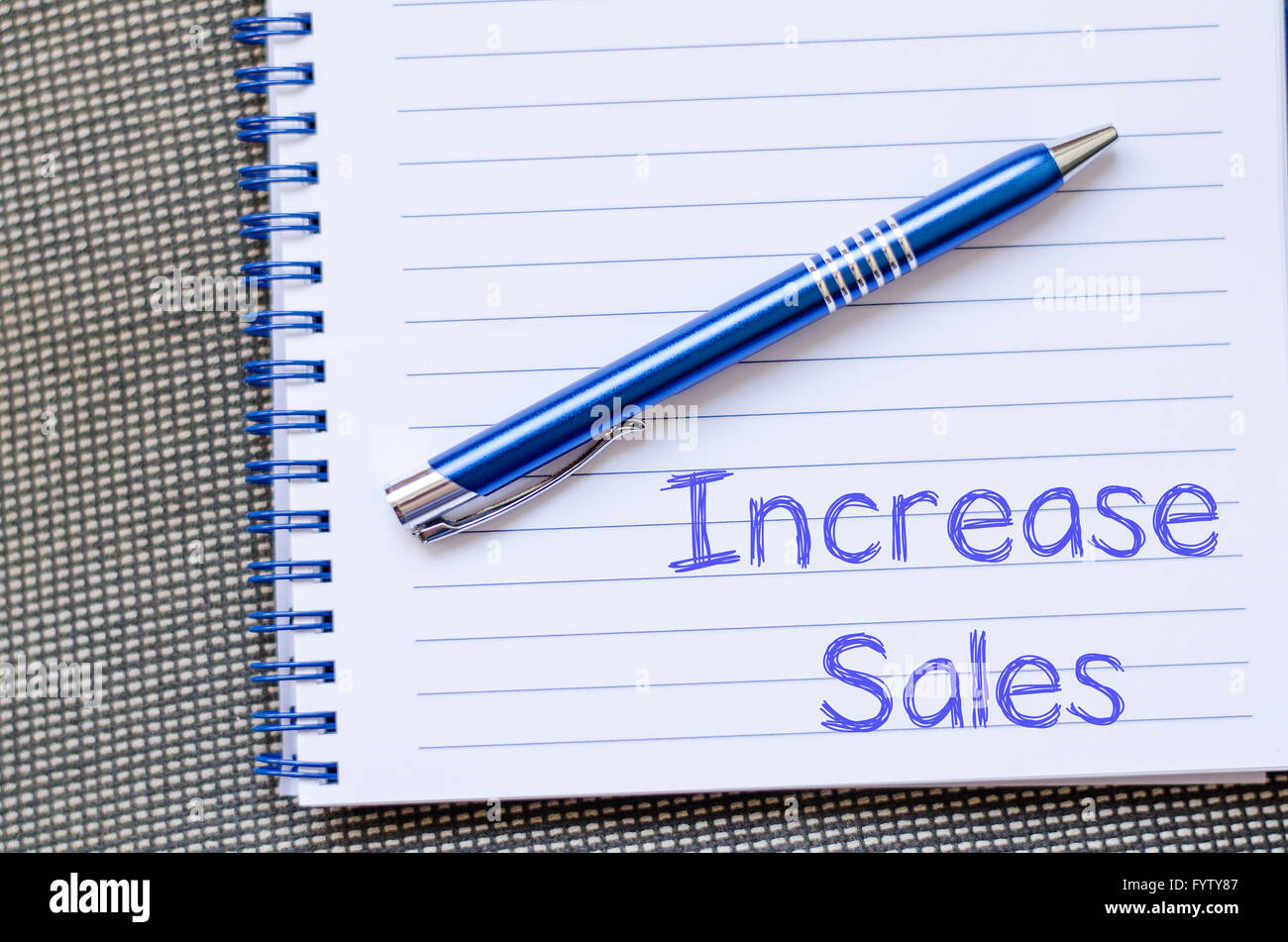 Increase sales write on notebook Stock Photo - Alamy