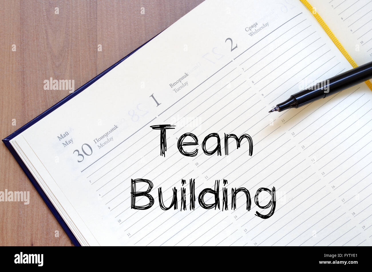 Team building write on notebook Stock Photo - Alamy
