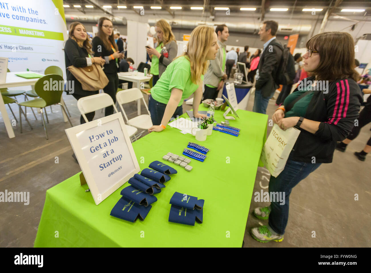 Worker from Betts, a job recruitment service, talks to a visitor at the ...