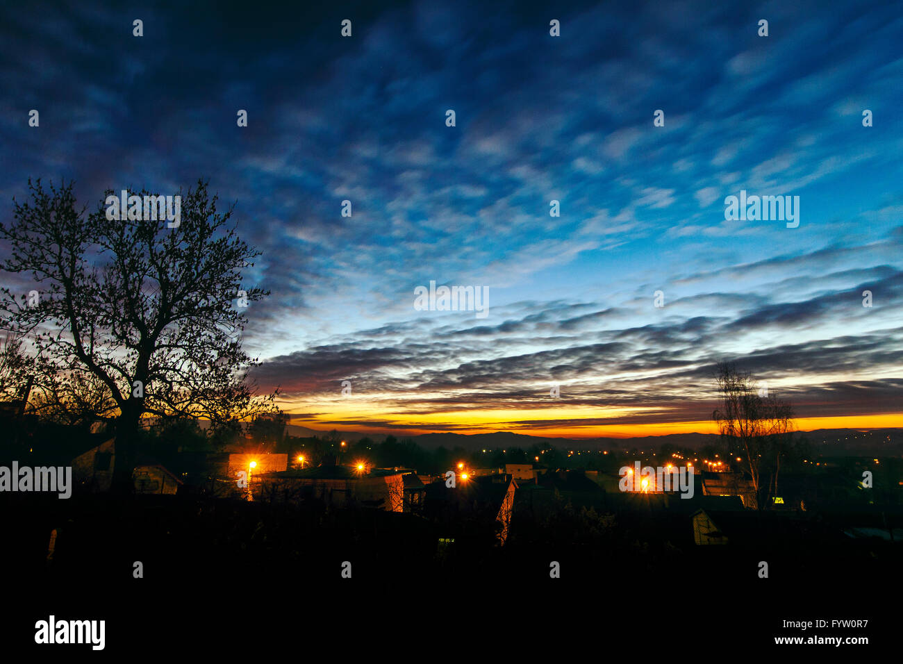 Beautiful sky covered with clouds just after sunset over the city ...