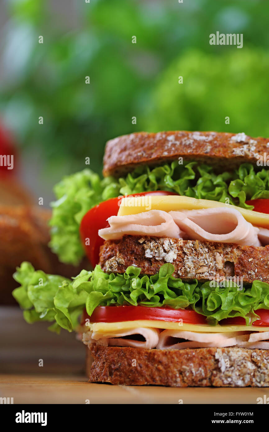 Double sandwich with brown bread, ham, lettuce, tomato, cheese Stock ...