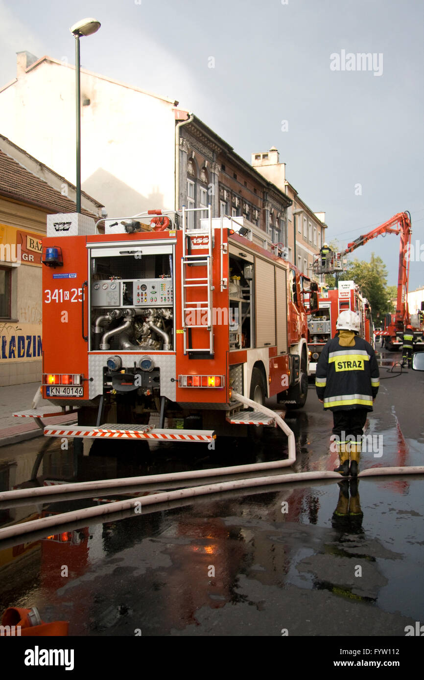 Firefighter standing on the hose and watching the fire in Nowy Sącz ...