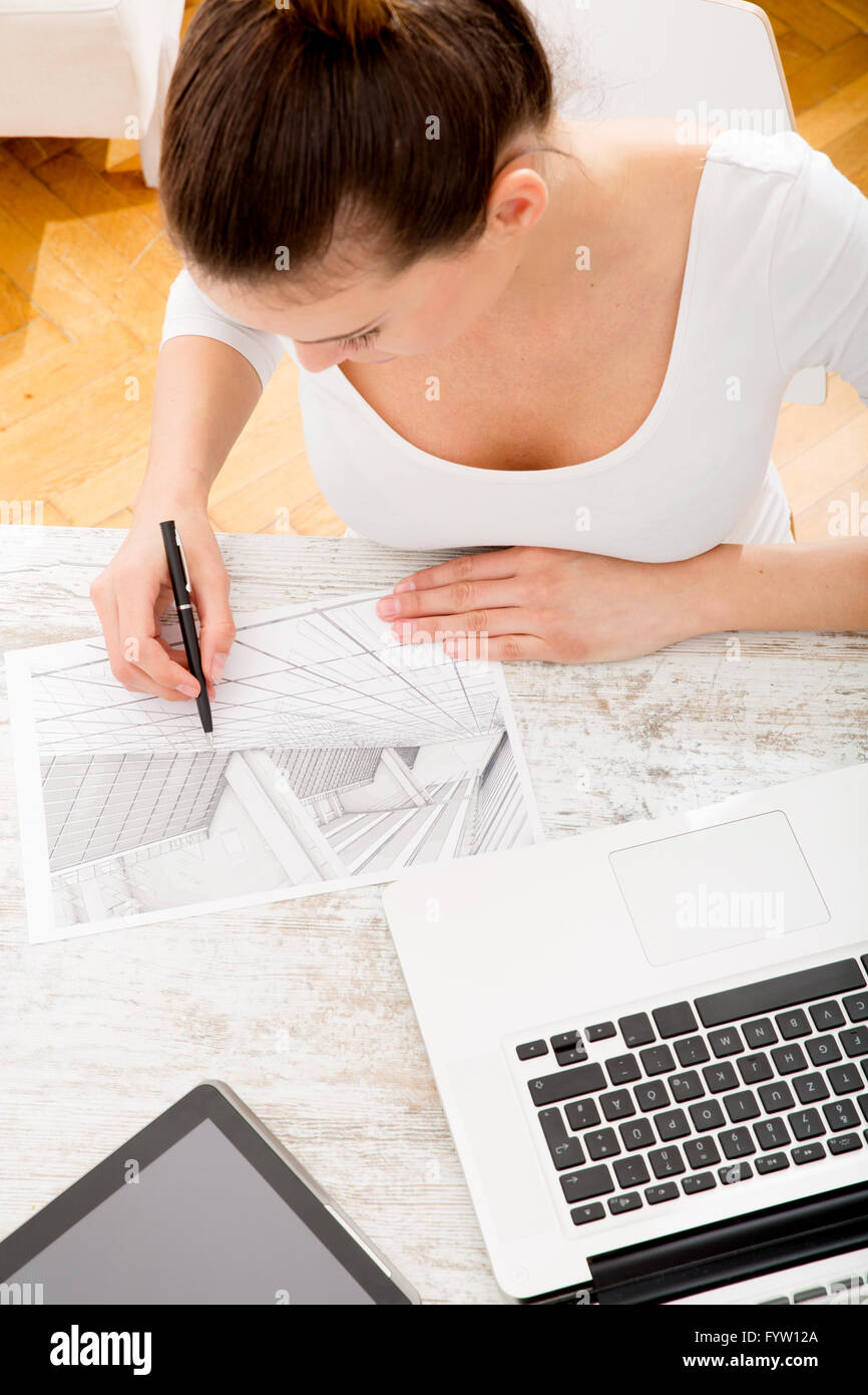 Woman drawing a blueprint Stock Photo - Alamy