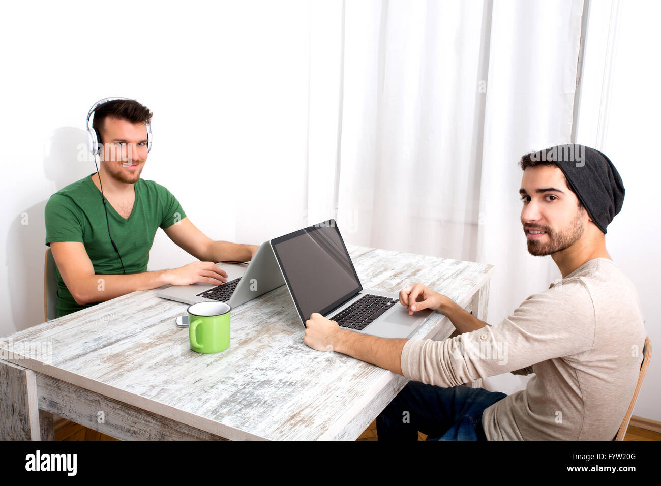 Two men working in their home office Stock Photo - Alamy