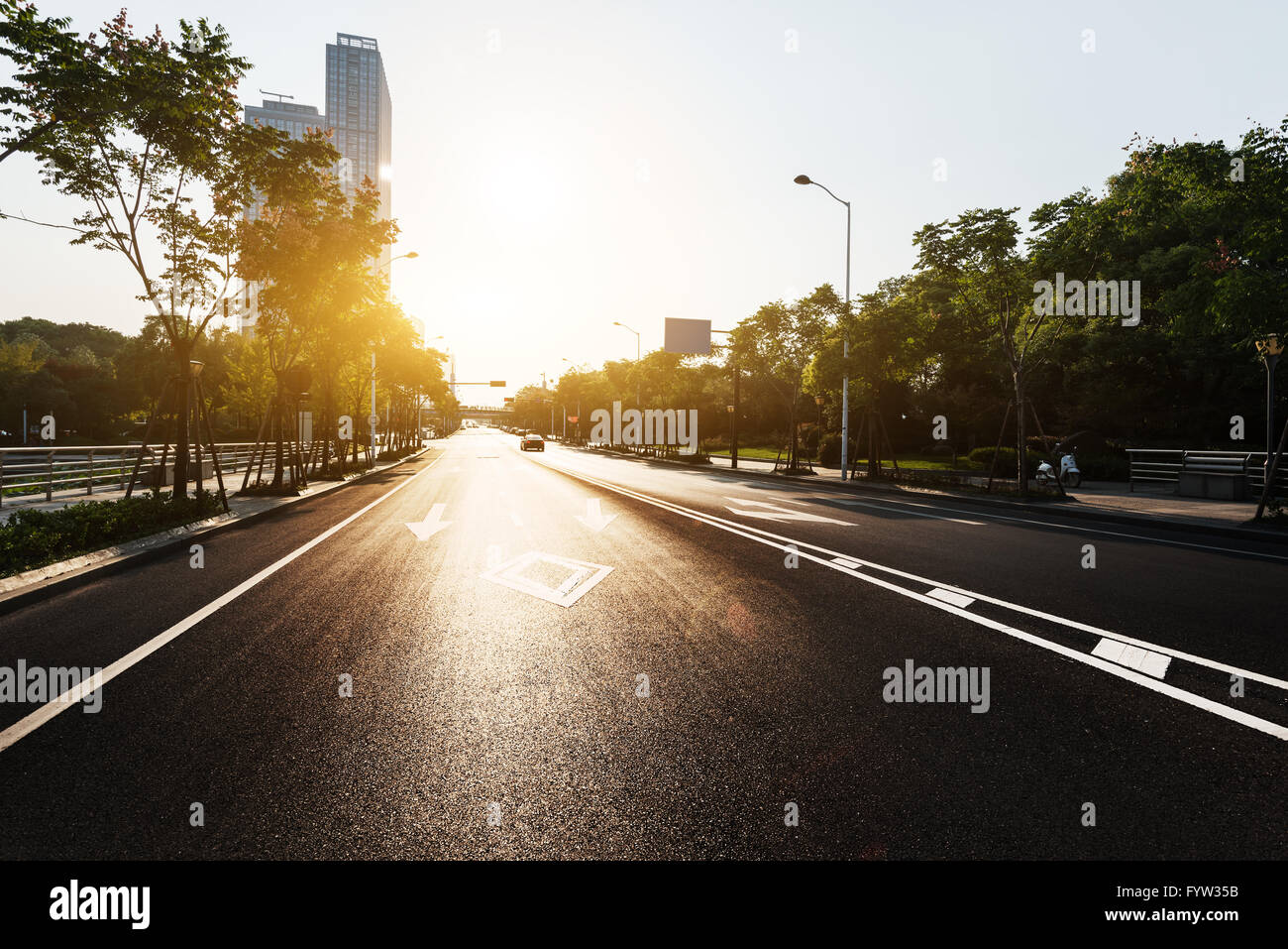 sunlight sky and road by buildings Stock Photo - Alamy