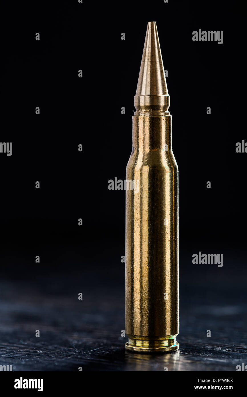 Large-caliber cartridge on a dark background Stock Photo - Alamy