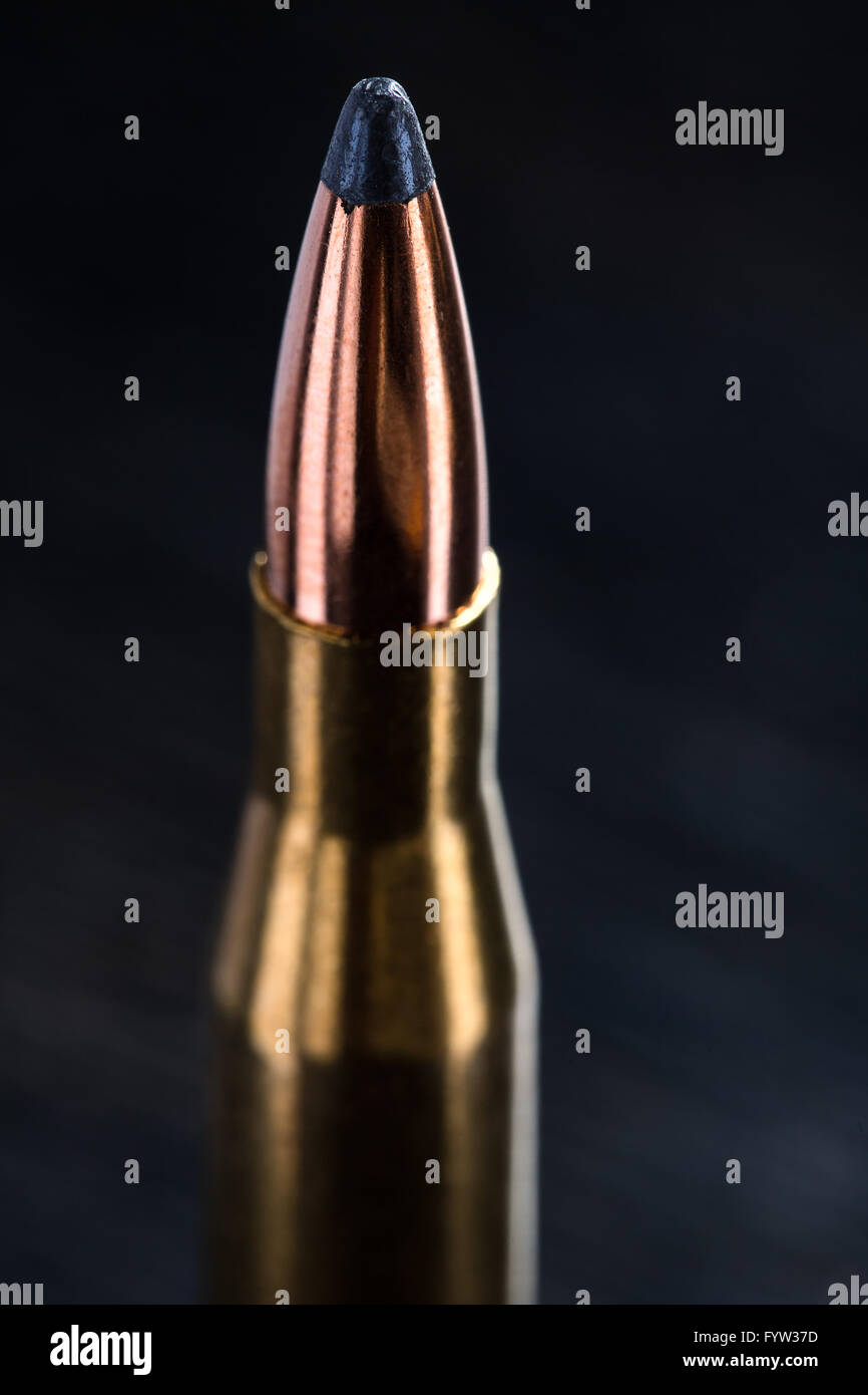 Large-caliber cartridge on a dark background Stock Photo - Alamy