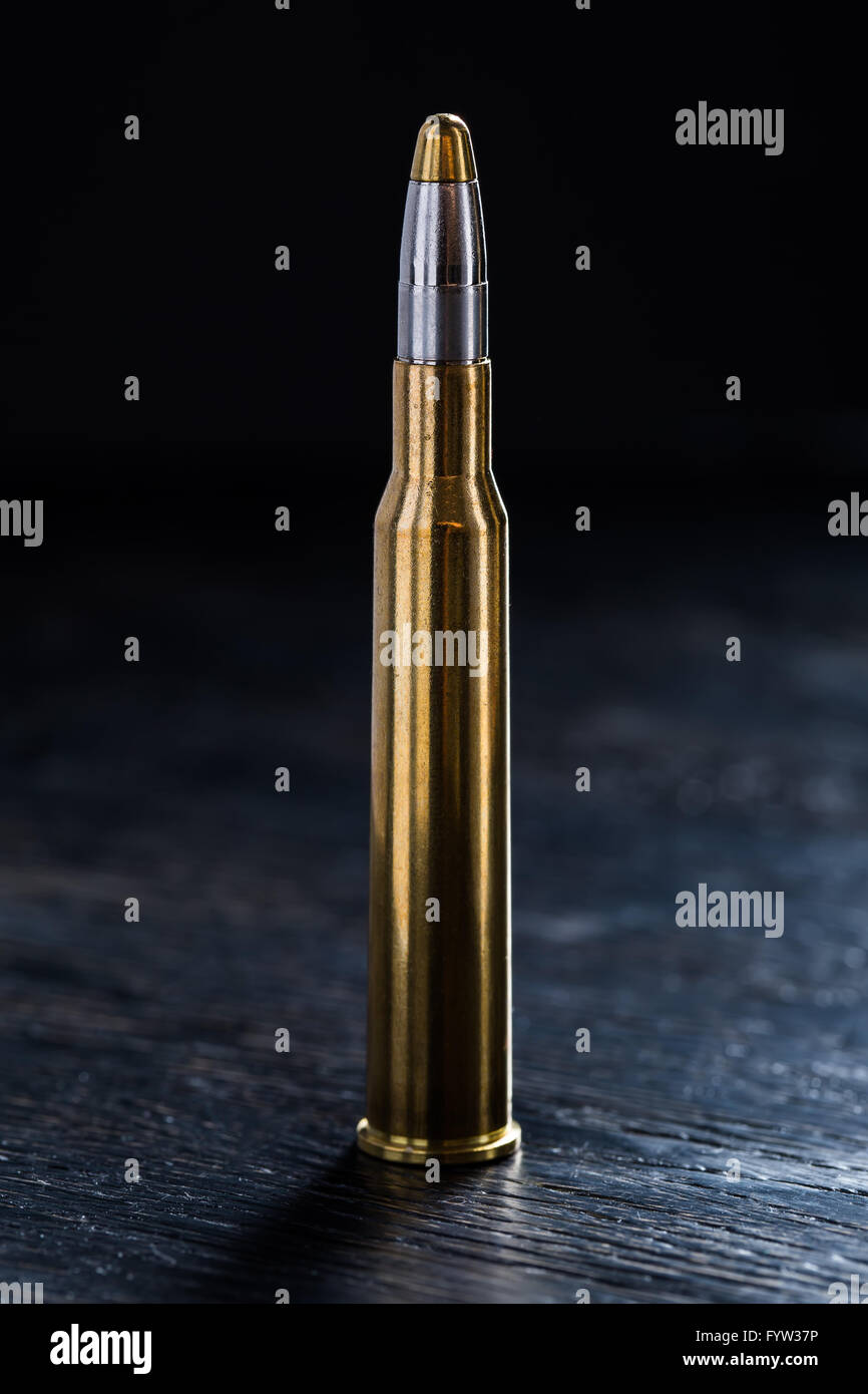 Large-caliber cartridge on a dark background Stock Photo - Alamy
