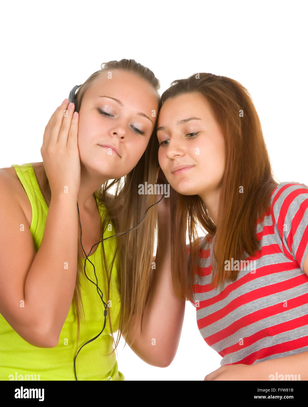 Two teenage girls listening to music on your mobile phone Stock Photo ...
