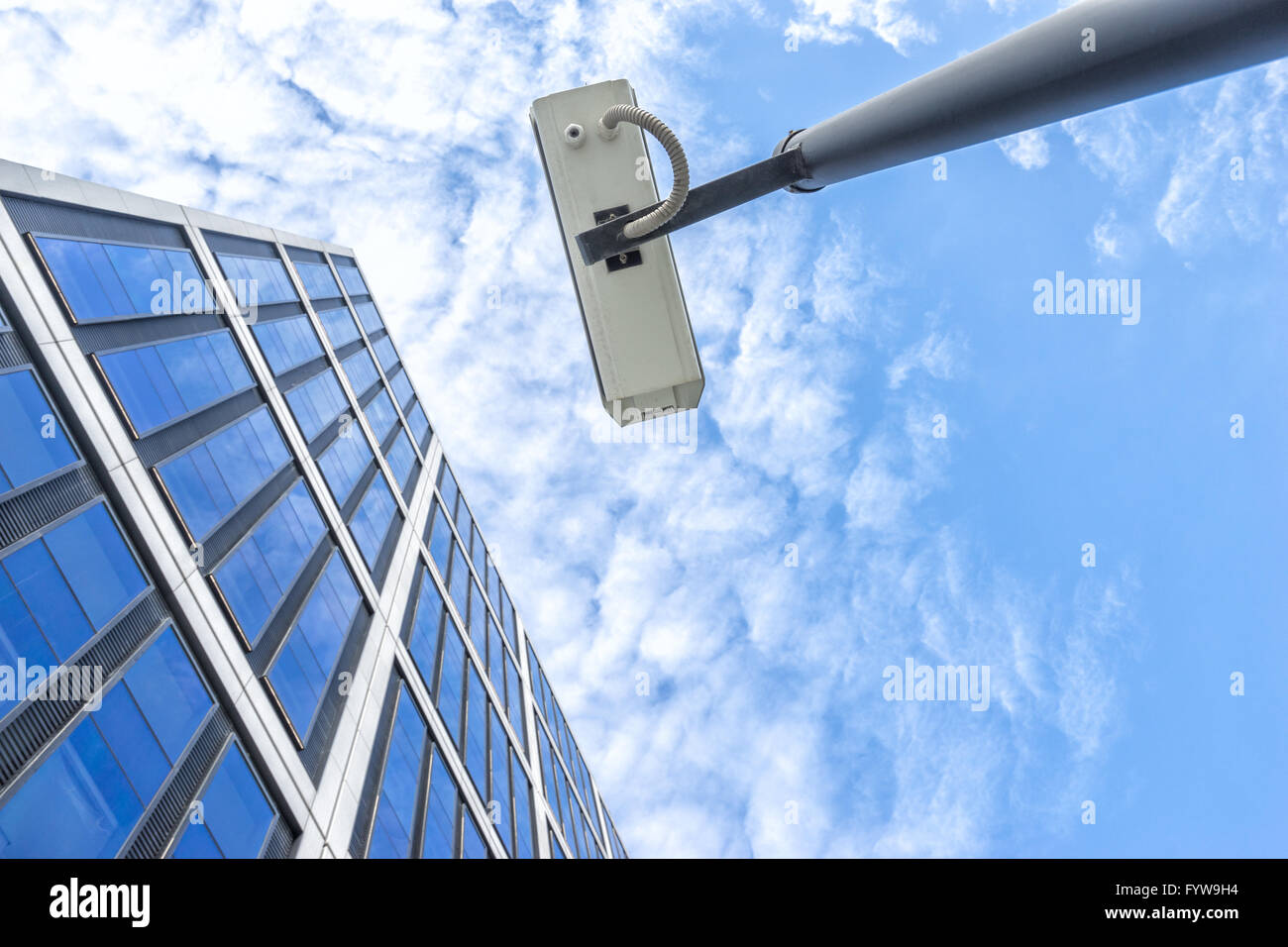 spy on pole near modern building in blue sky Stock Photo - Alamy