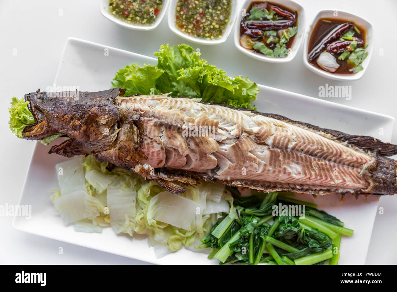 Grilled fish with vegetable and sauce on white background Stock Photo ...