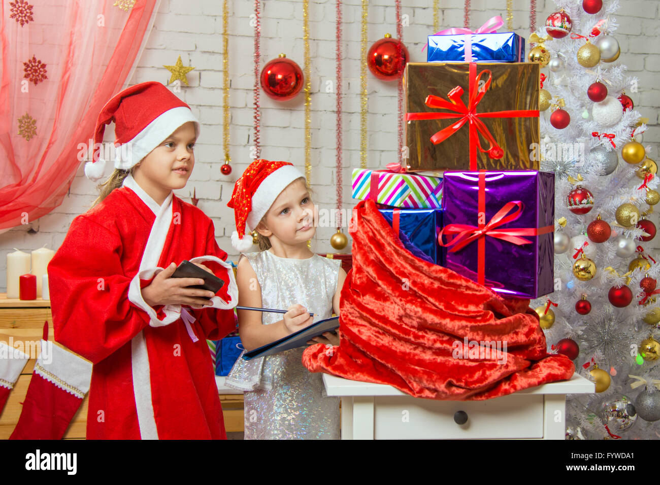 Santa Claus helper and collate a list of gifts Stock Photo - Alamy