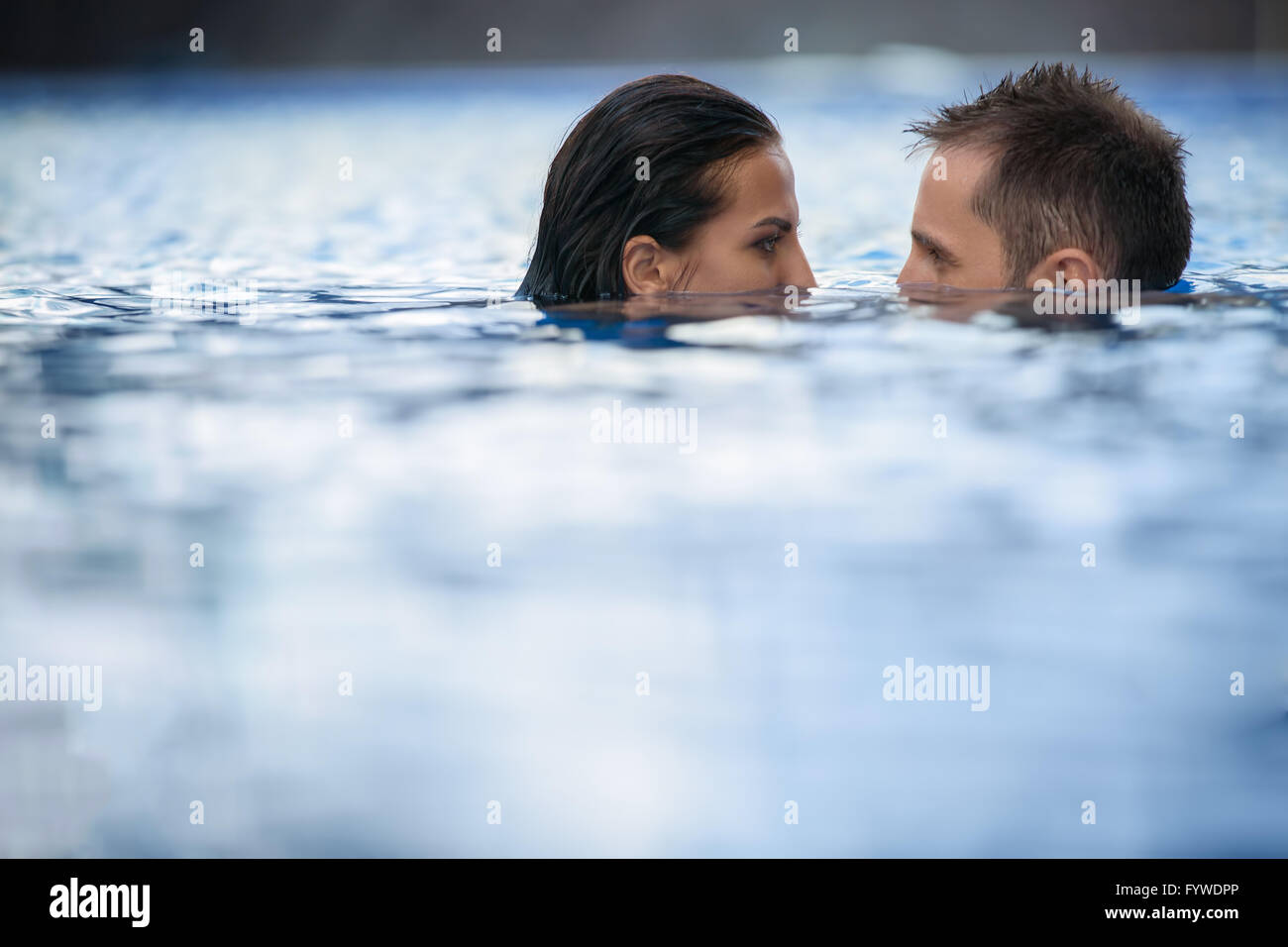 Couple in the pool Stock Photo - Alamy