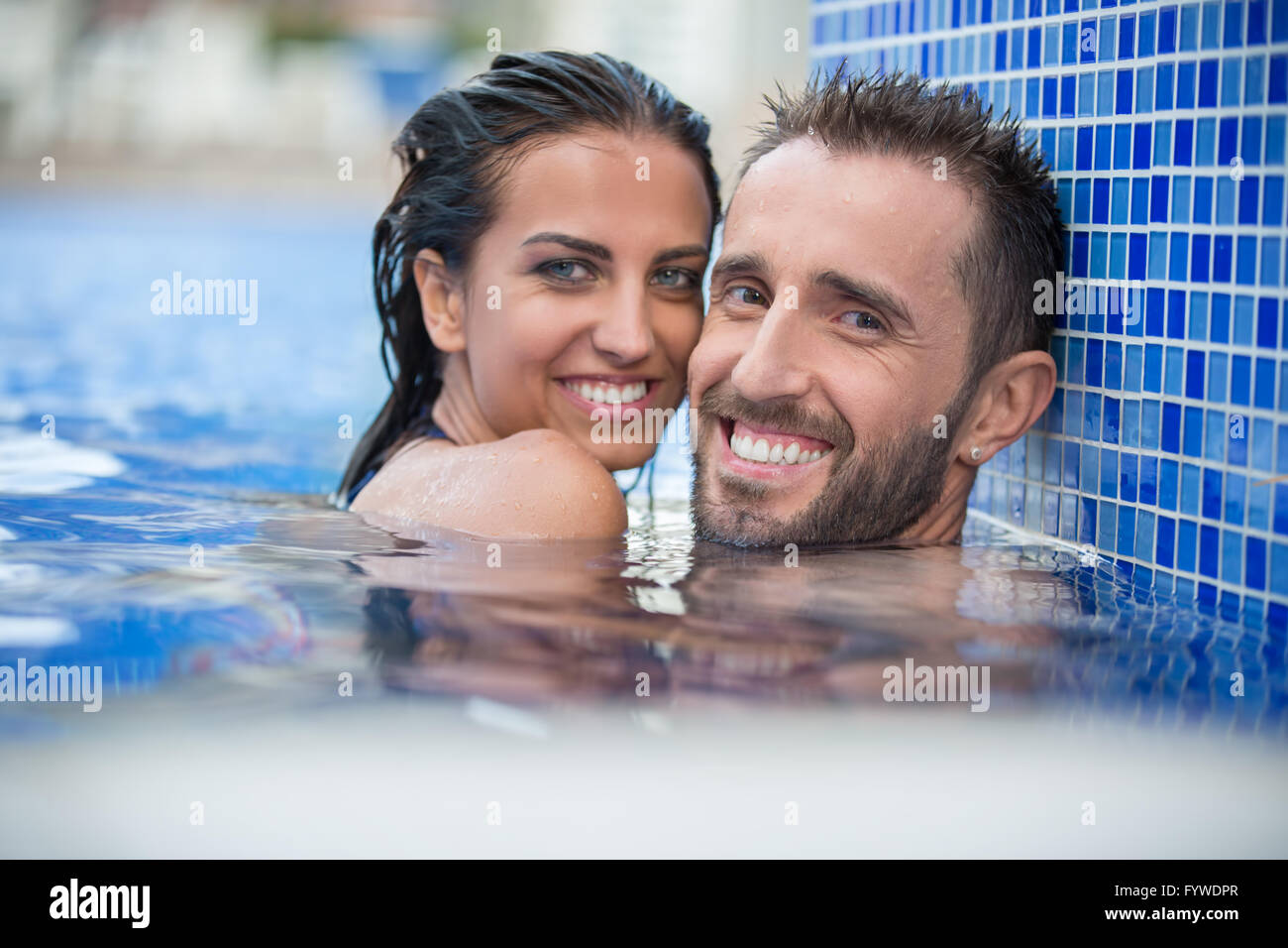 Couple in the pool Stock Photo - Alamy