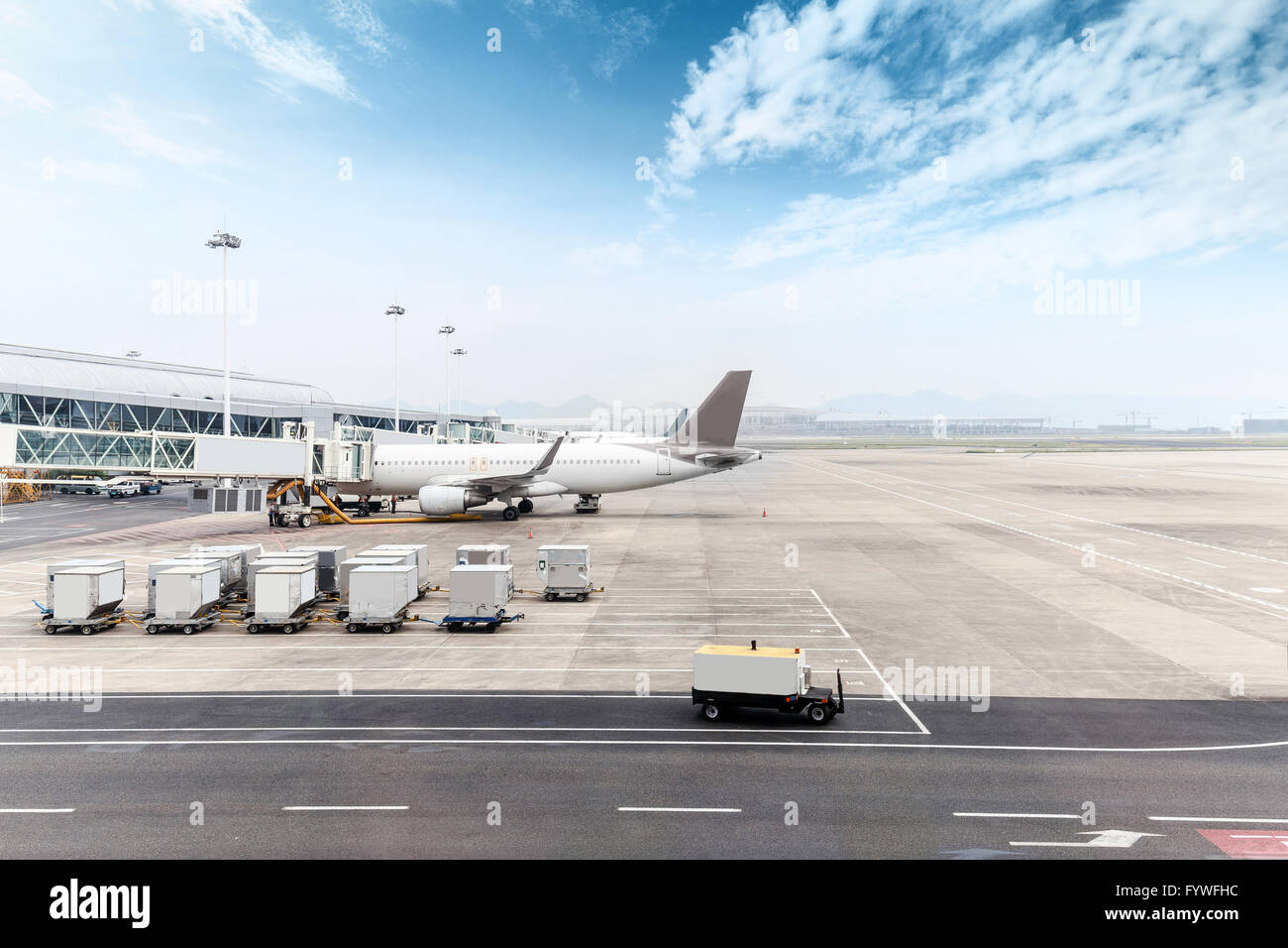 cloudy skyline and airplane on airport ramp Stock Photo - Alamy