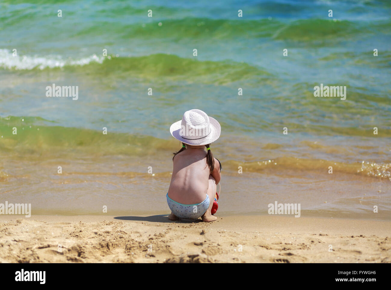 Baby girl sitting on the beach hi-res stock photography and images - Alamy