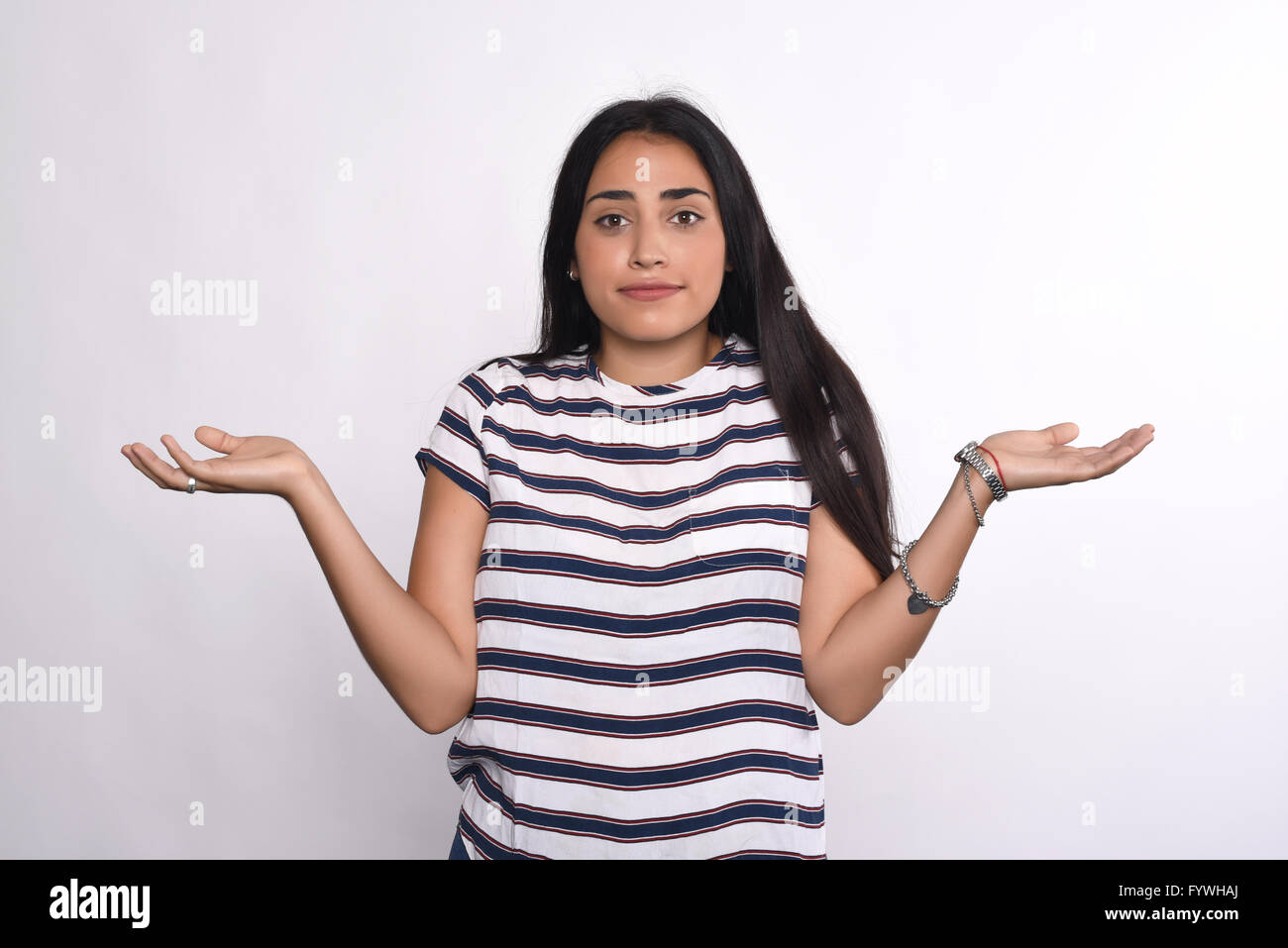 Indecisive young woman with arms open. Isolated white background Stock ...