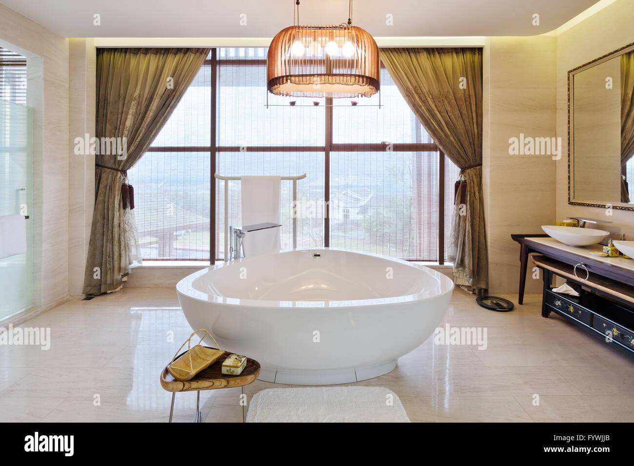 interior of modern bathroom with big bathtub Stock Photo - Alamy