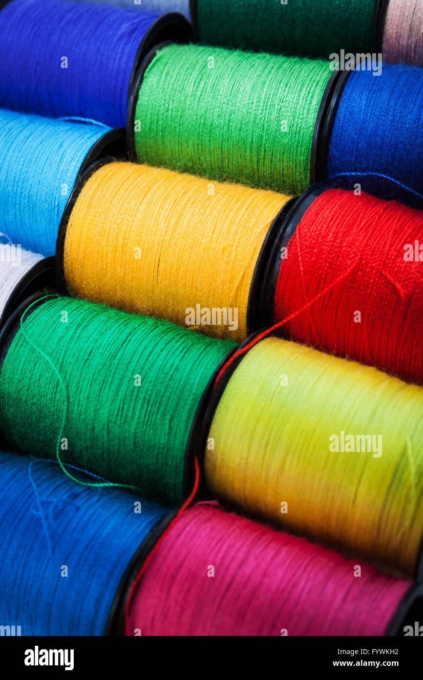 colorful threads on spools Stock Photo - Alamy