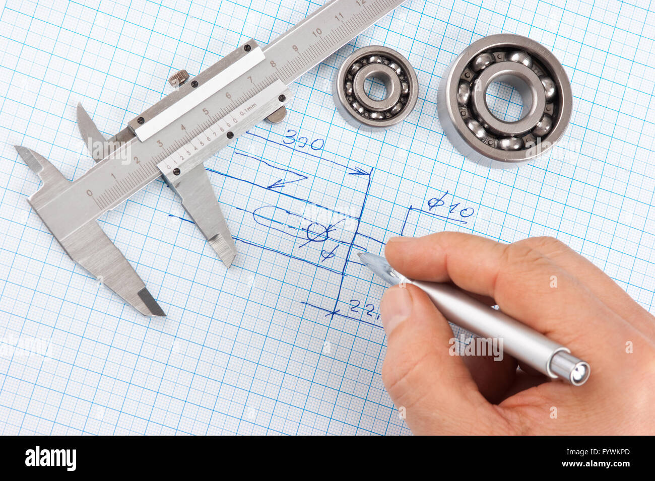 pen in hand and technical drawing Stock Photo - Alamy