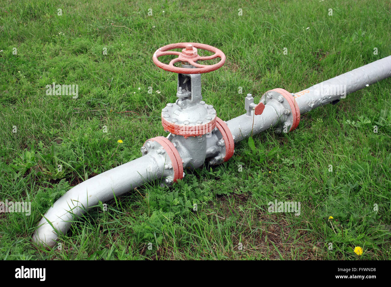 gas pipe line and valve that laid through green field Stock Photo - Alamy