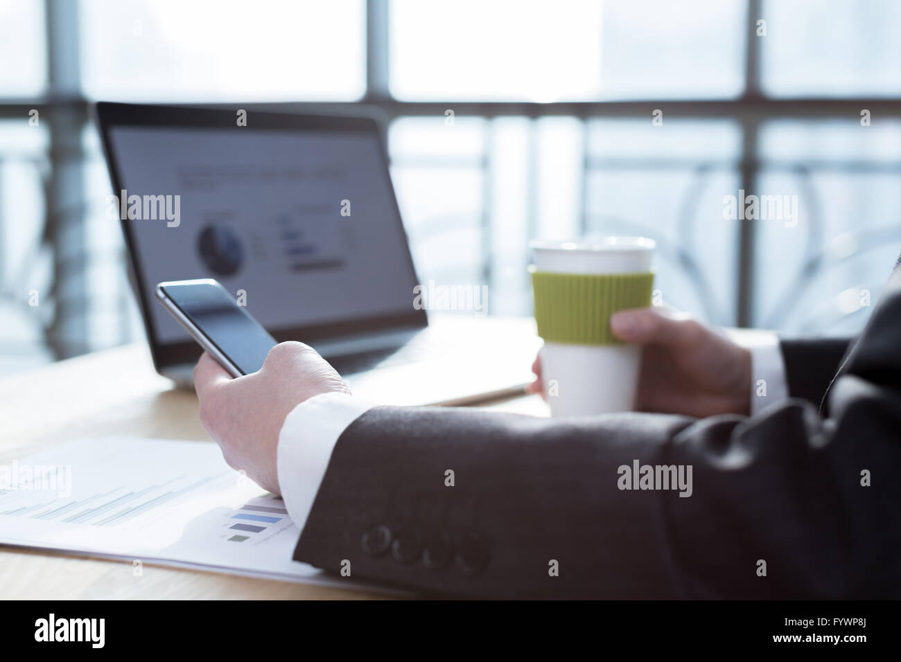 businessman looking through info on cell phone Stock Photo - Alamy