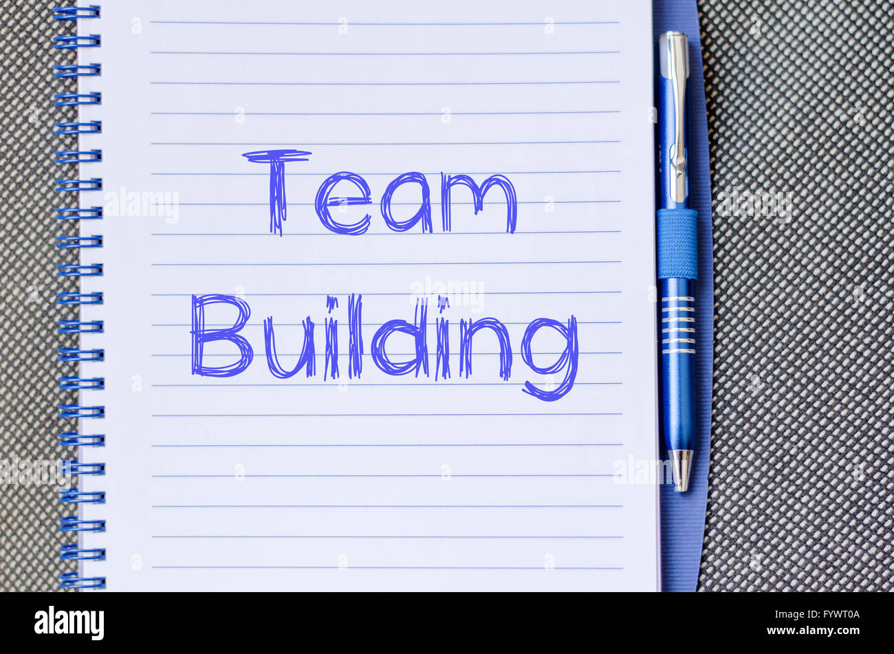 Team building write on notebook Stock Photo - Alamy