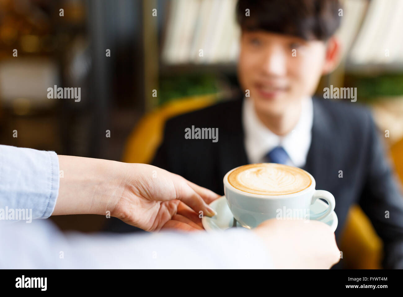 waitress serving for young customer in cafe Stock Photo - Alamy