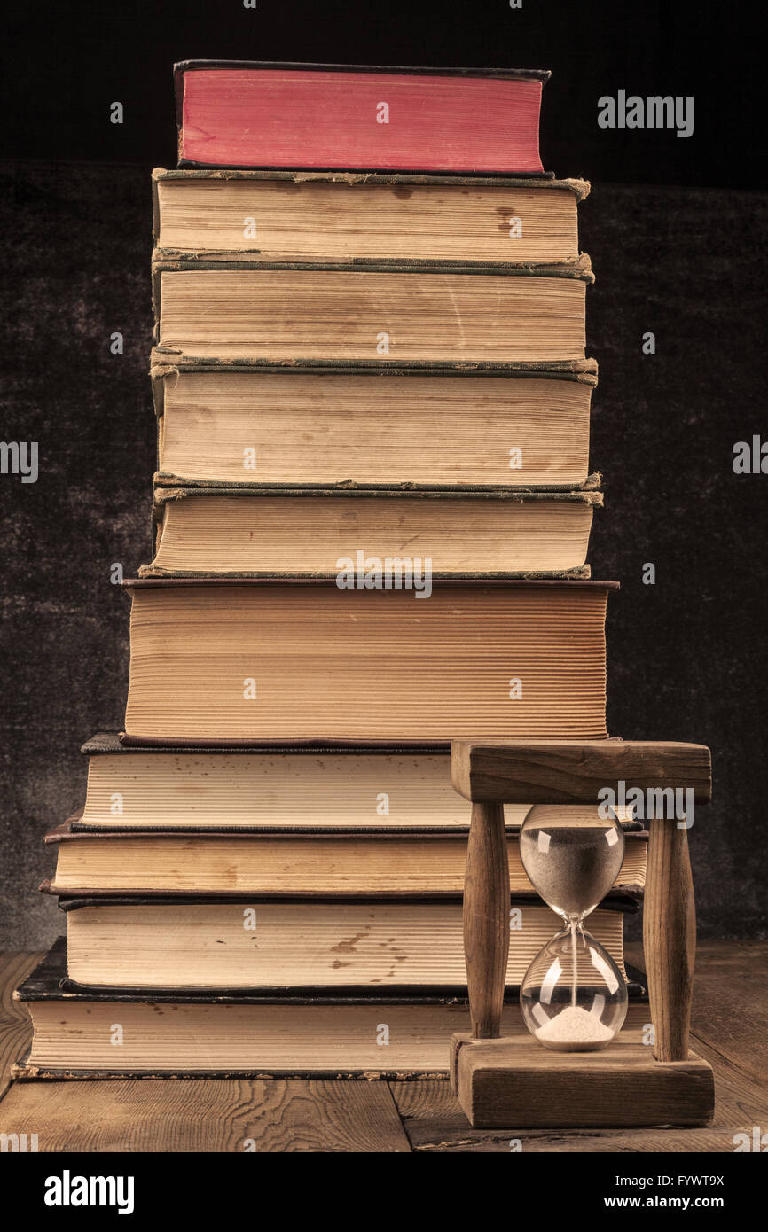 Hourglass and Books Stock Photo - Alamy