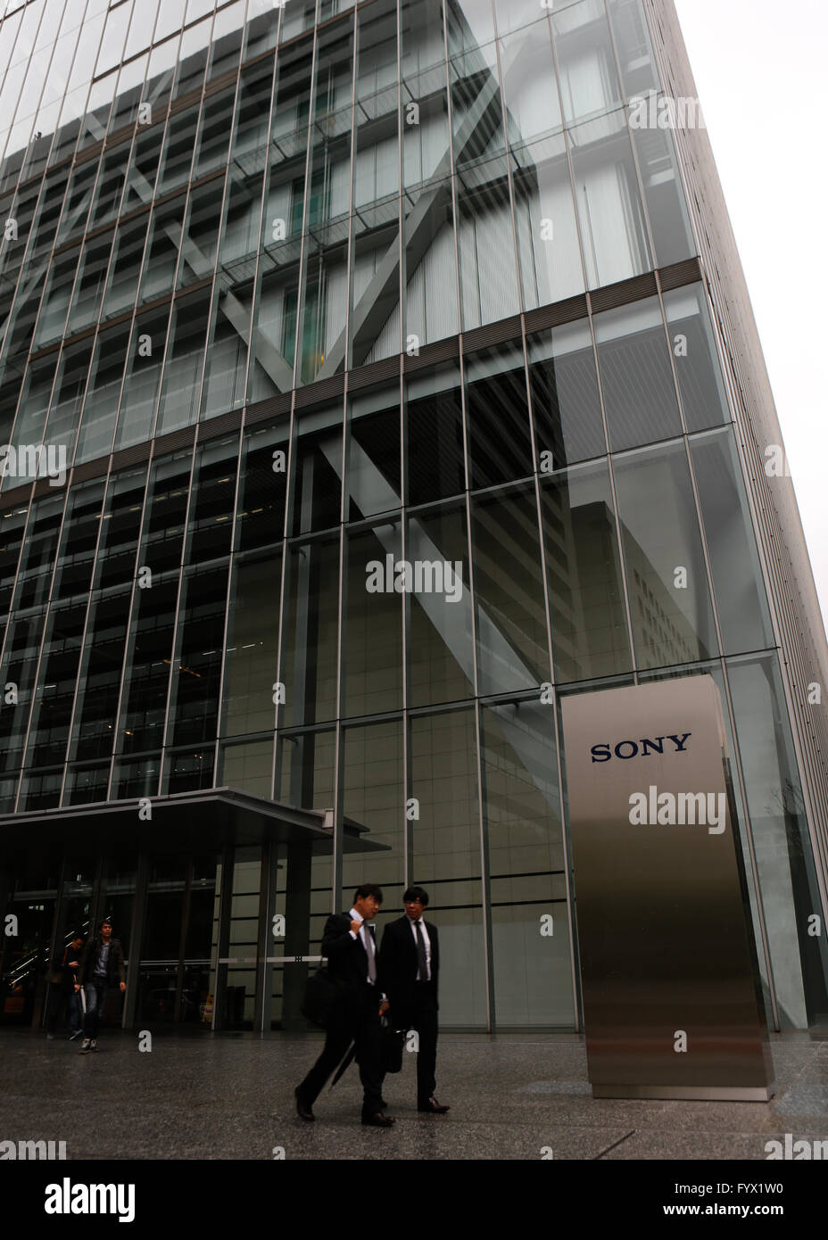 Tokyo, Japan. 28th Apr, 2016. Businessmen walk outside of the Sony ...
