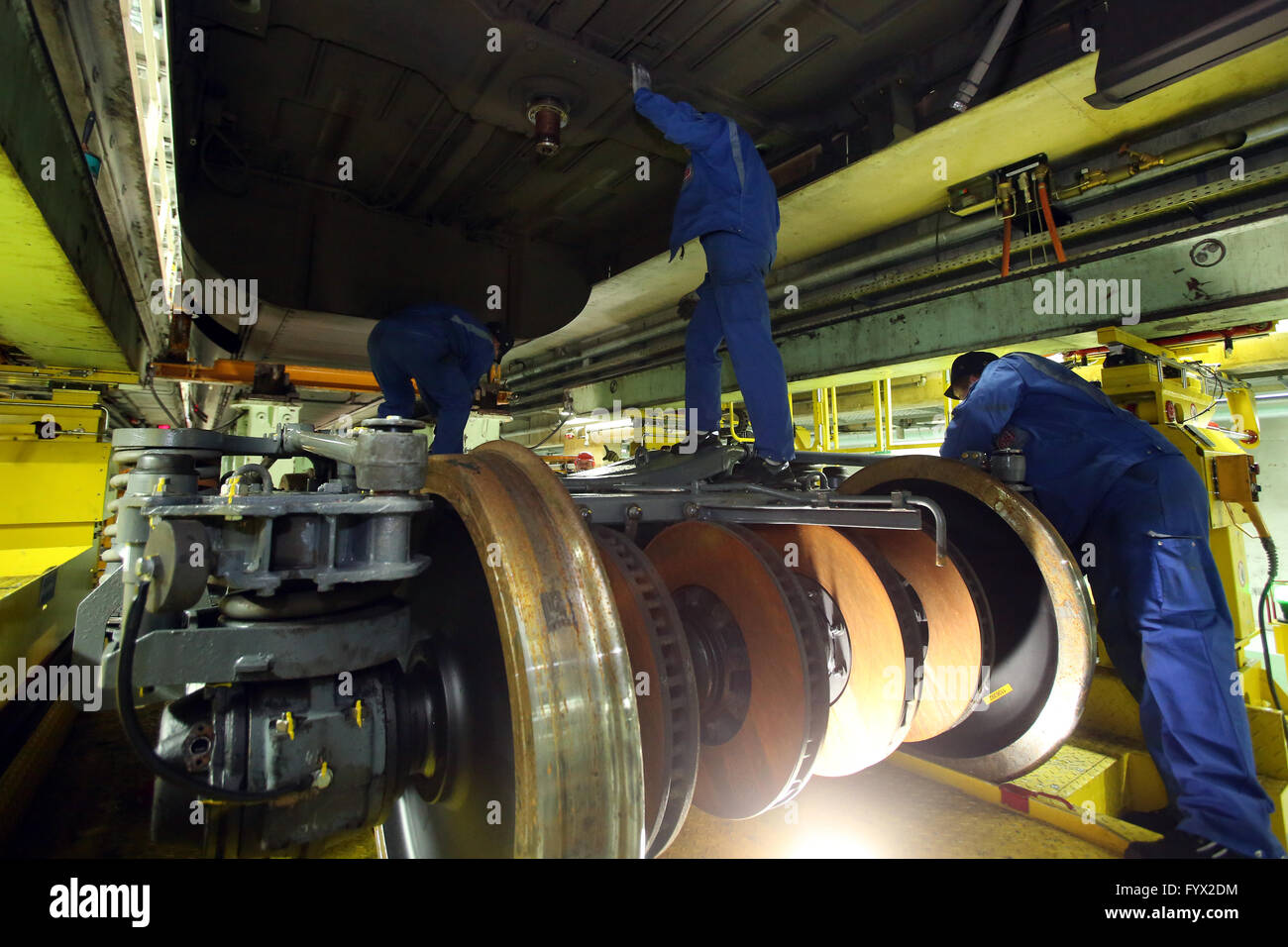 Hamburg, Germany. 26th Apr, 2016. Employees install a bogie on an ...