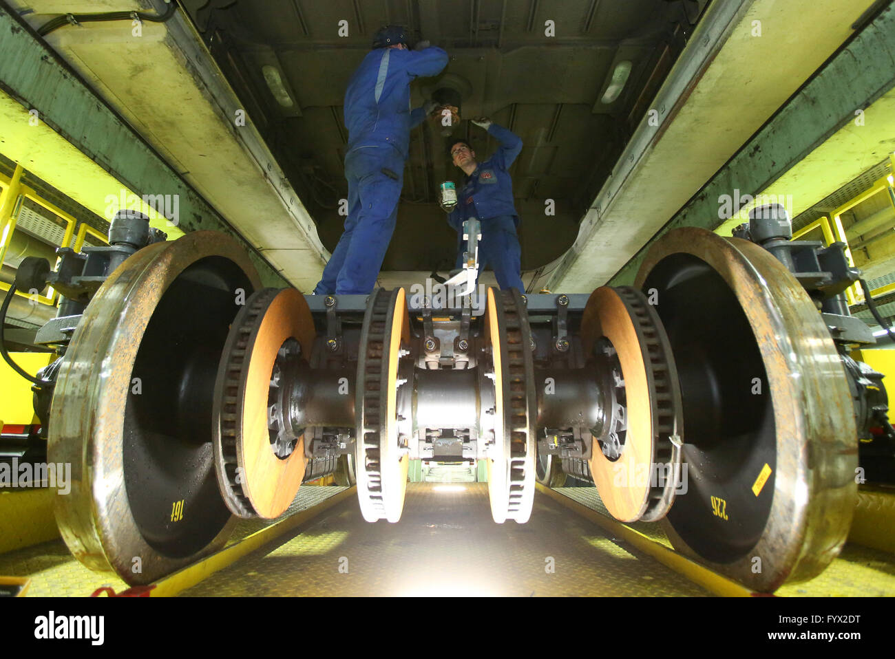 Hamburg, Germany. 26th Apr, 2016. Employees install a bogie on an ...