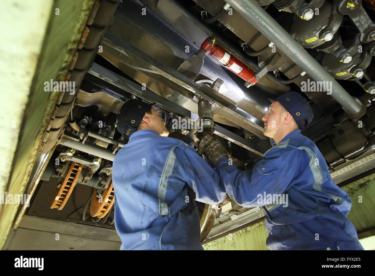 Hamburg, Germany. 26th Apr, 2016. Employees work on a bogie of an ...