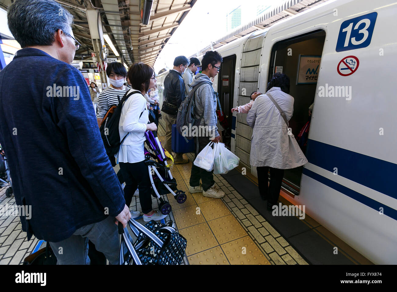 Passengers board a Shinkansen (bullet train) at Tokyo station on April ...
