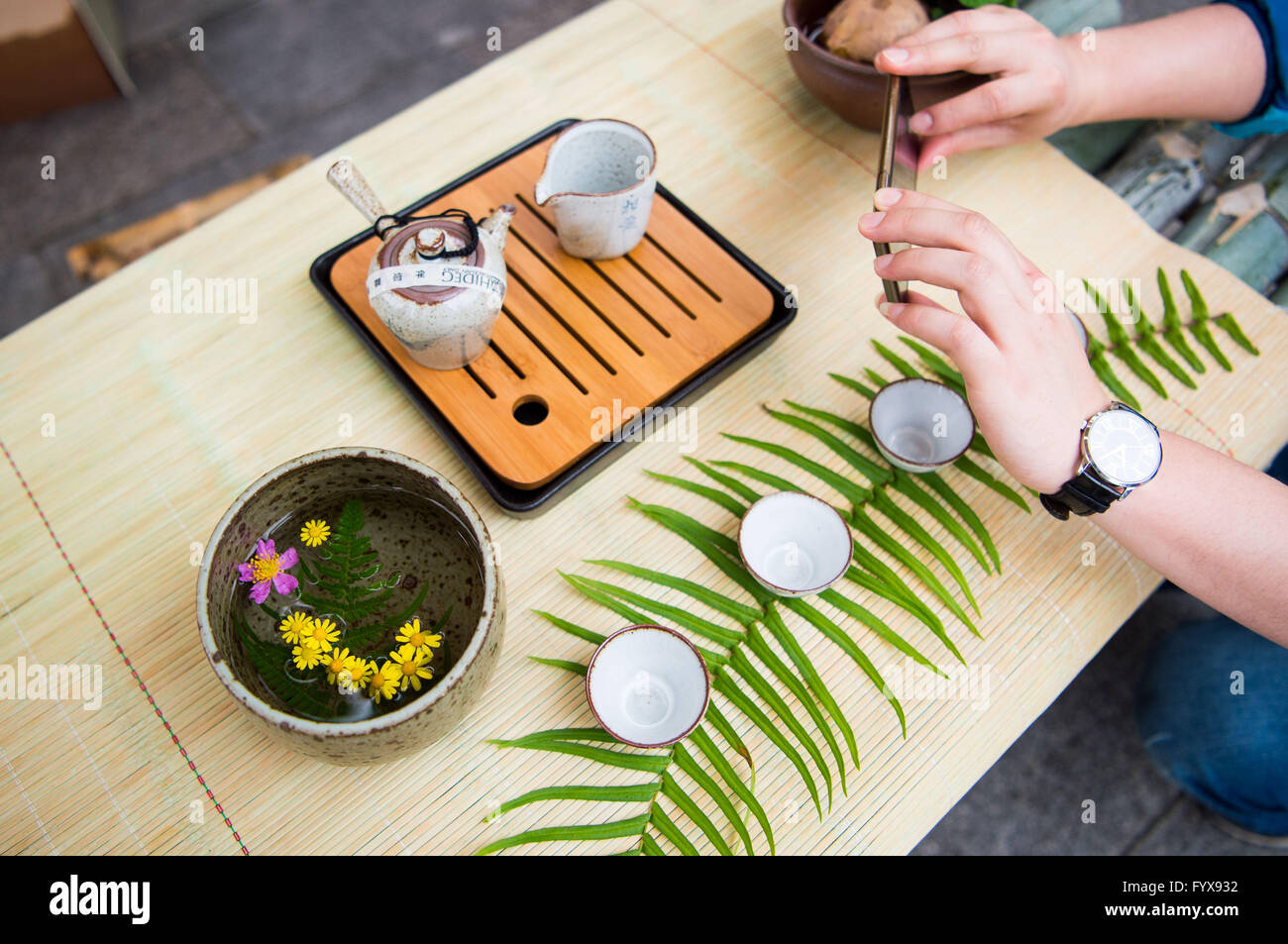Chongqing. 29th Apr, 2016. A tourist takes photos of the tea set at the ...
