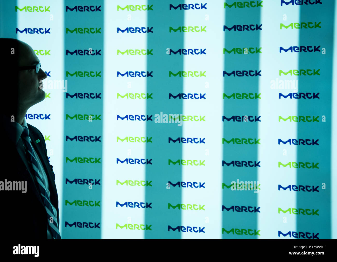 A Merck employee presenting liquid crystal windows with different ...