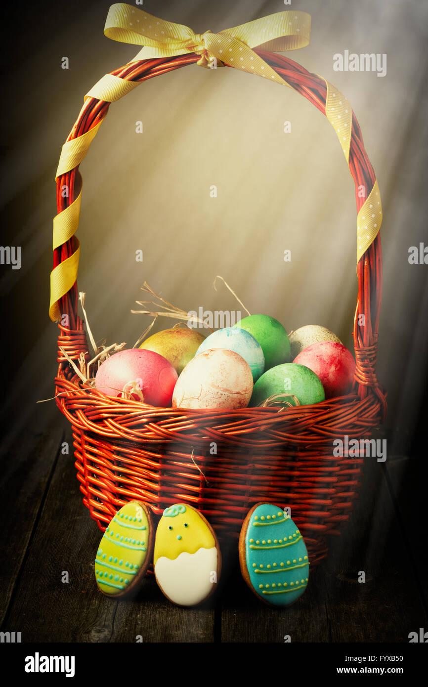 Colored easter eggs in basket Stock Photo - Alamy
