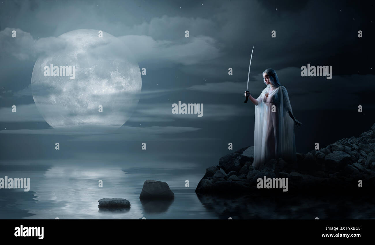 Young elven girl with sword on night sea coast Stock Photo - Alamy
