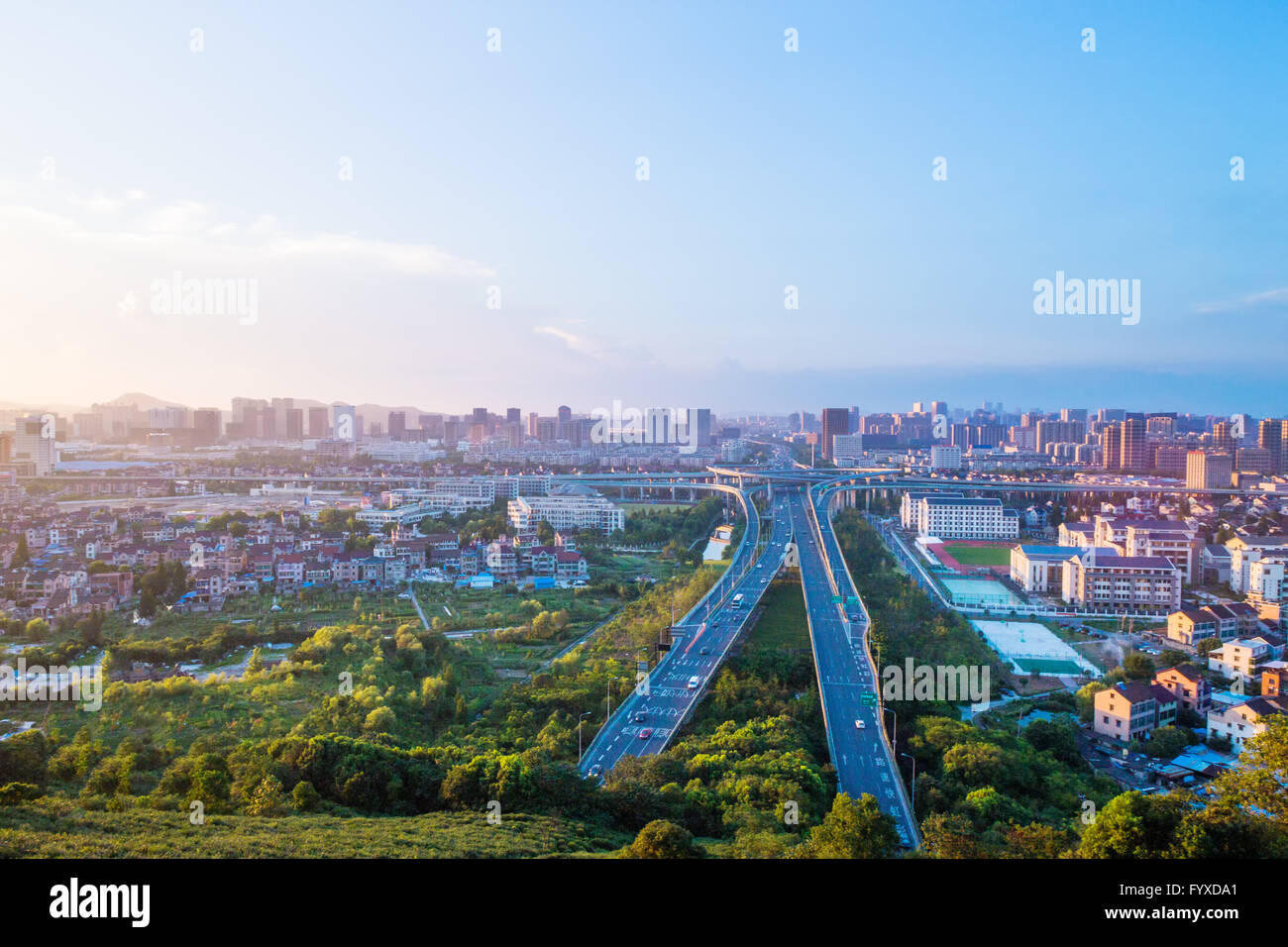 city road through buildings in blue sky Stock Photo - Alamy