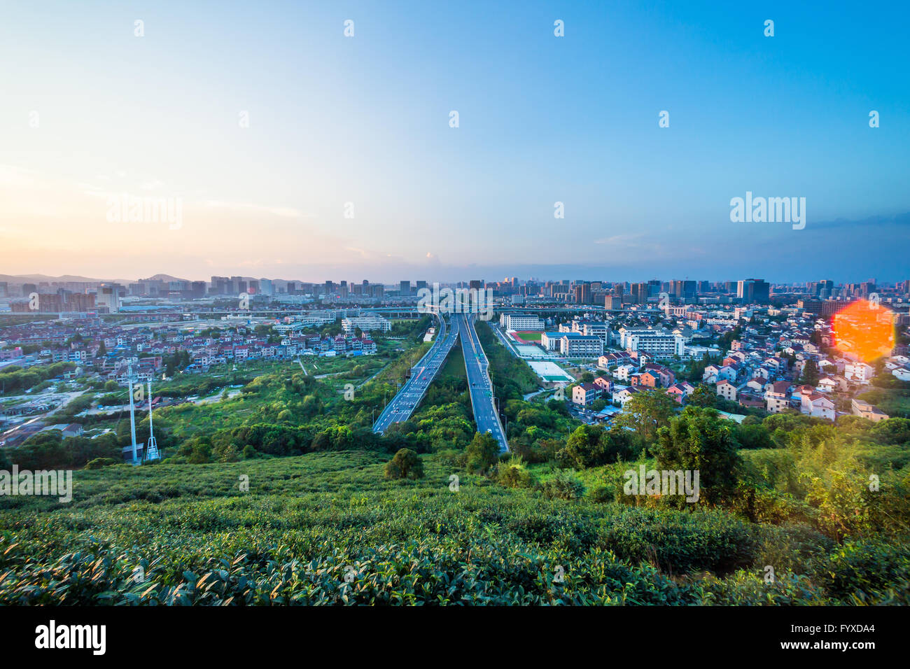 city road through buildings in blue sky Stock Photo - Alamy