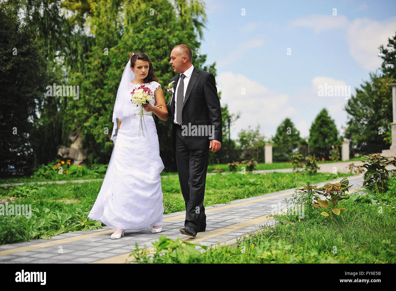 Wedding adult couple walking on the trail Stock Photo - Alamy