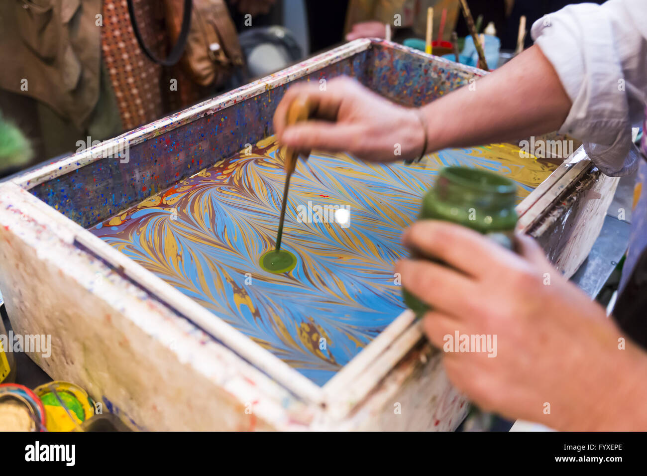 Painting on water human hand Stock Photo - Alamy