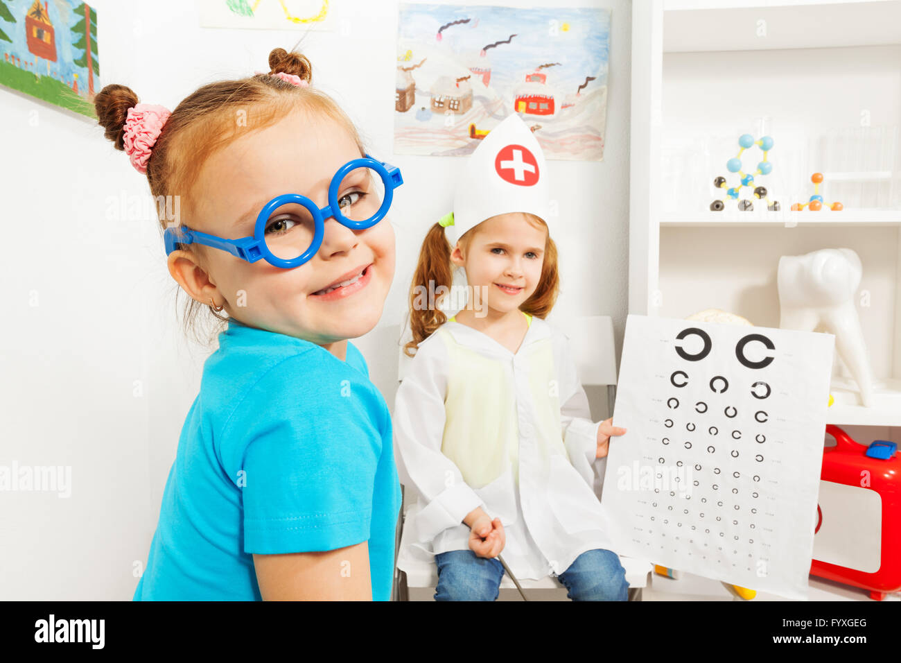 Girl in blue toy glasses at ophthalmologist room Stock Photo - Alamy