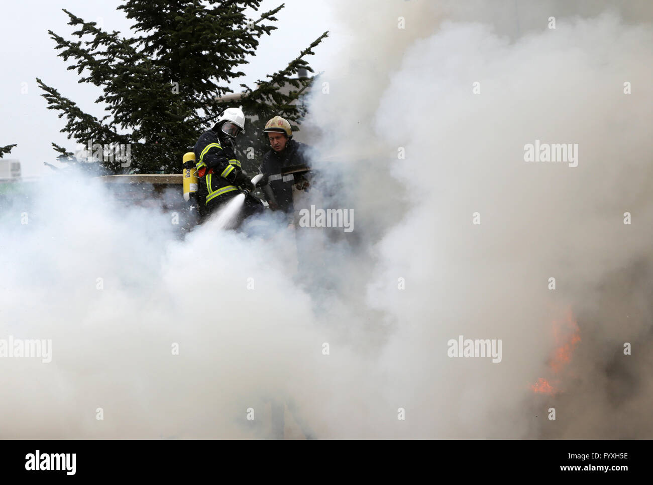 Firefighters on burning house roof hi-res stock photography and images ...