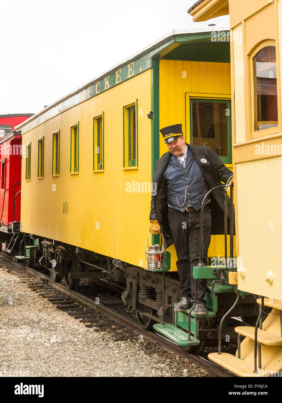 Conductor makes sure all riders are aboard Stock Photo - Alamy