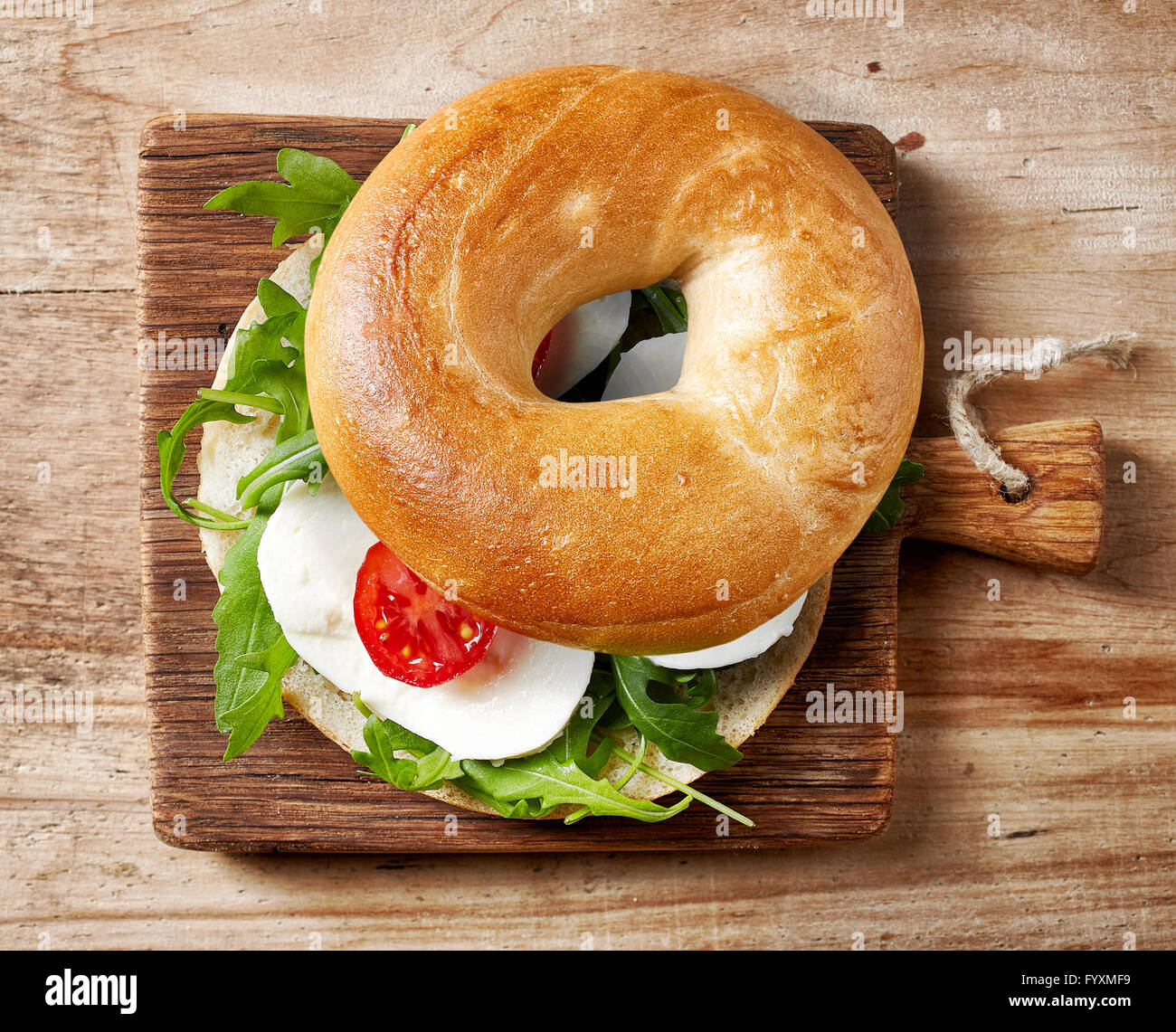 Fresh bagel sandwich on wooden table, top view Stock Photo - Alamy