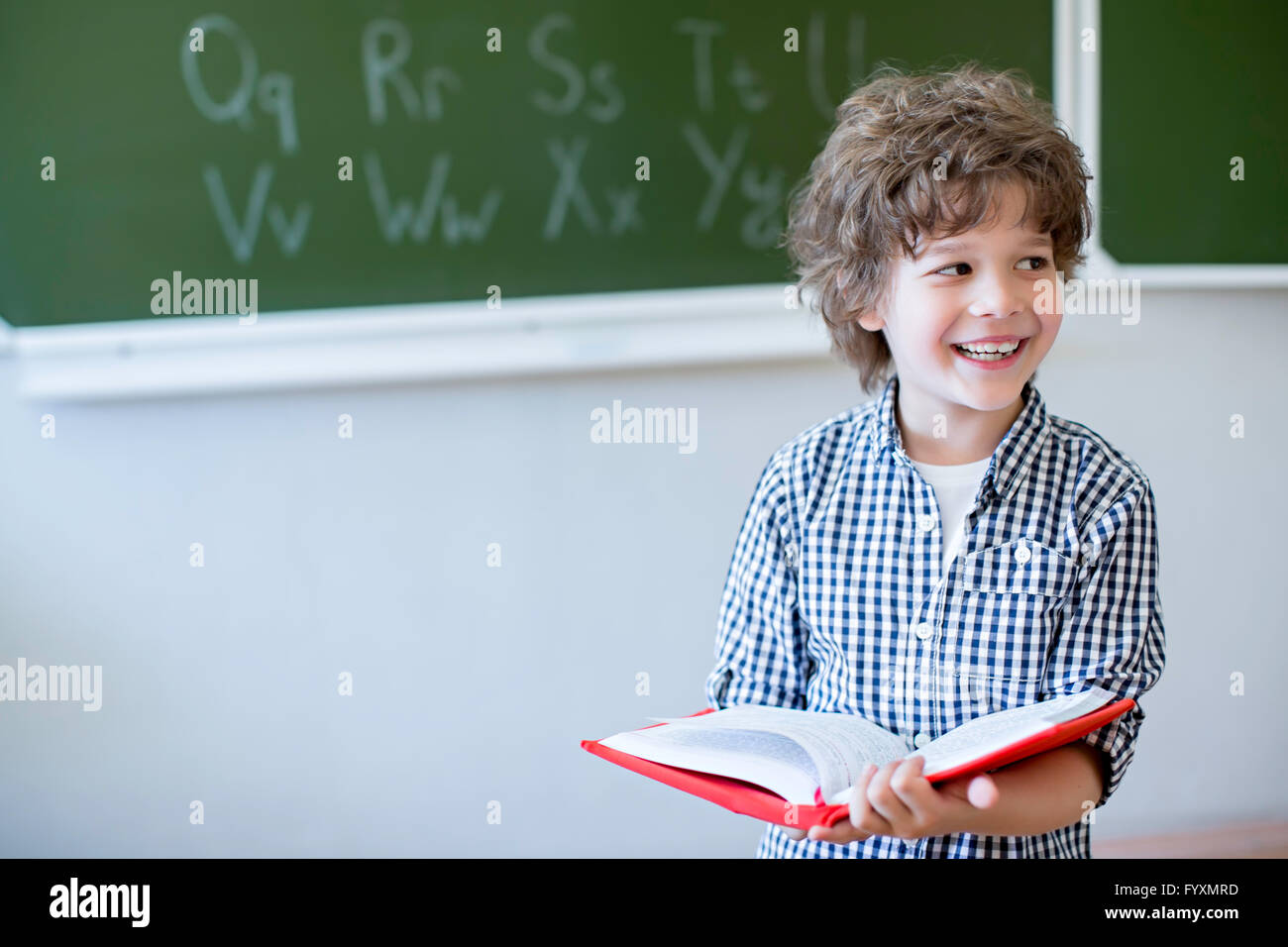 Boy with book Stock Photo - Alamy