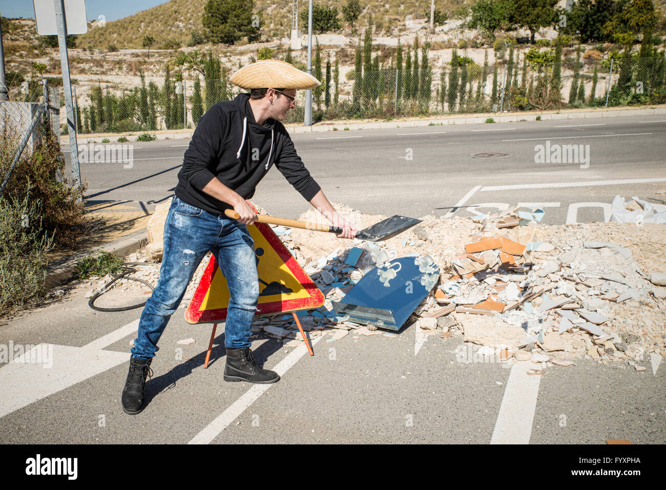 Young guy building a road block with construction rubble, a concept ...