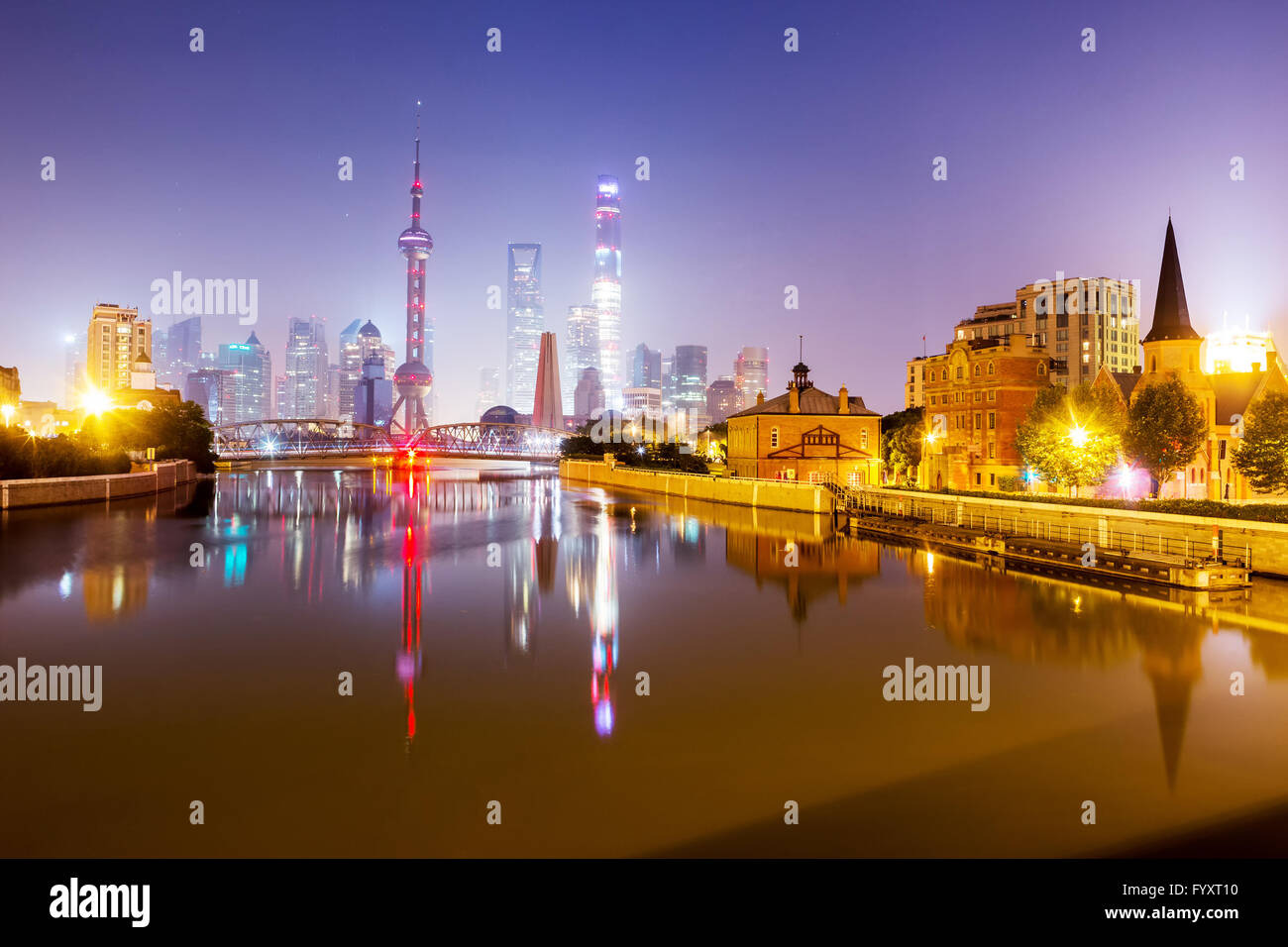waterfront cityscape and illuminated skyline at dawn Stock Photo - Alamy