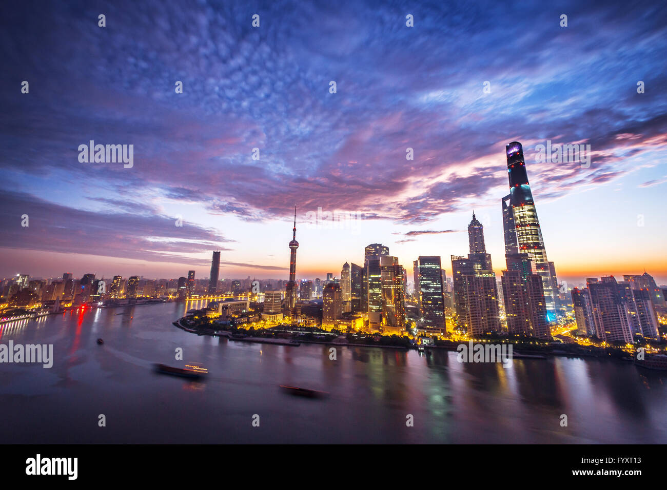 waterfront cityscape and illuminated skyline at dawn Stock Photo - Alamy